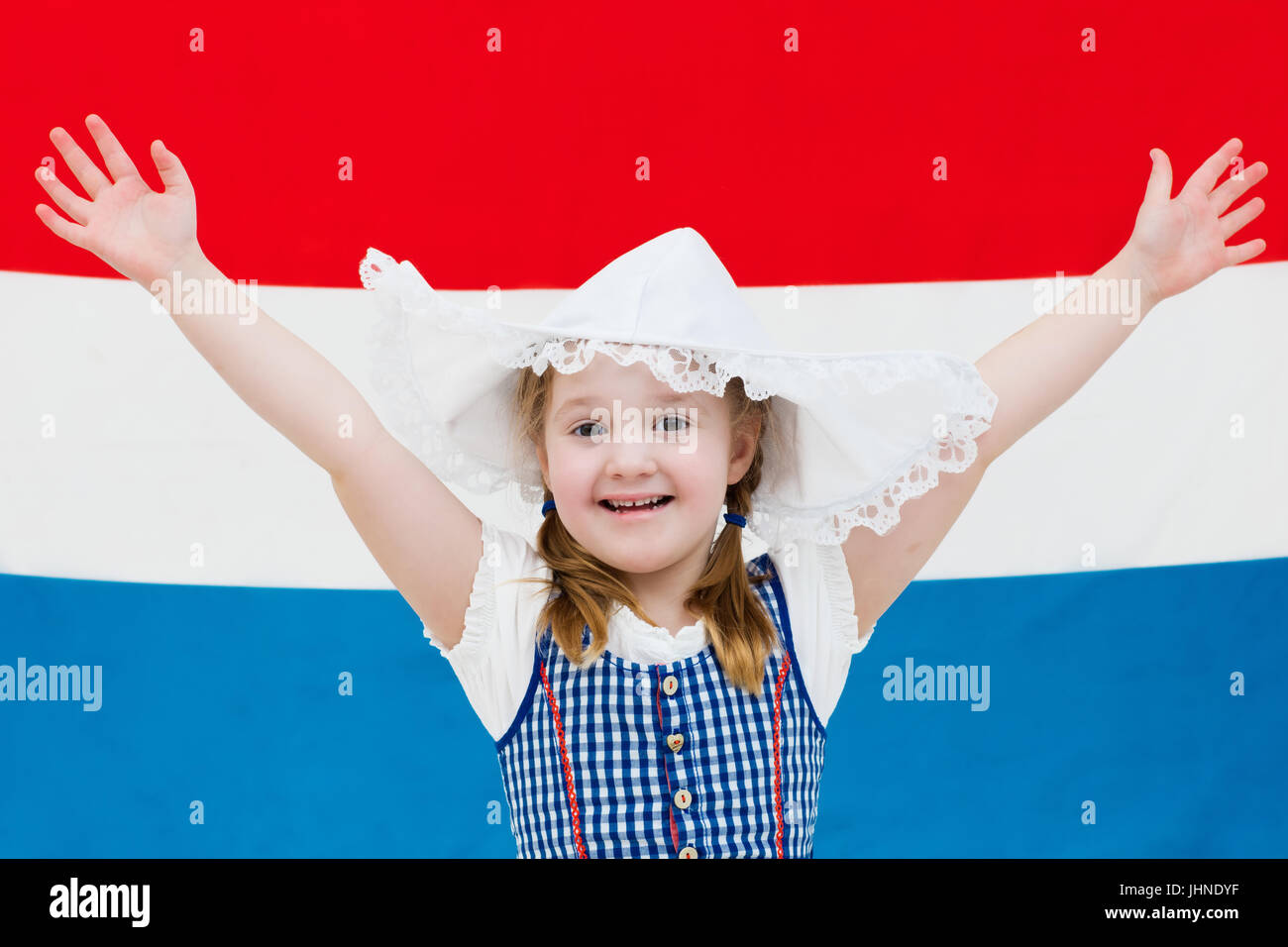 Little Dutch girl wearing traditional national costume, dress and hat ...