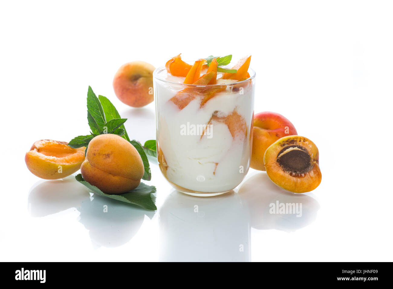 Sweet Greek yogurt with apricots on a white background Stock Photo - Alamy