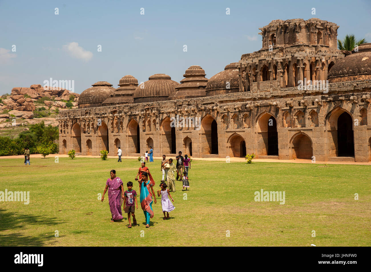 Indian woman passing by the Elephant Stables, Hampi, Karnataka, India ...
