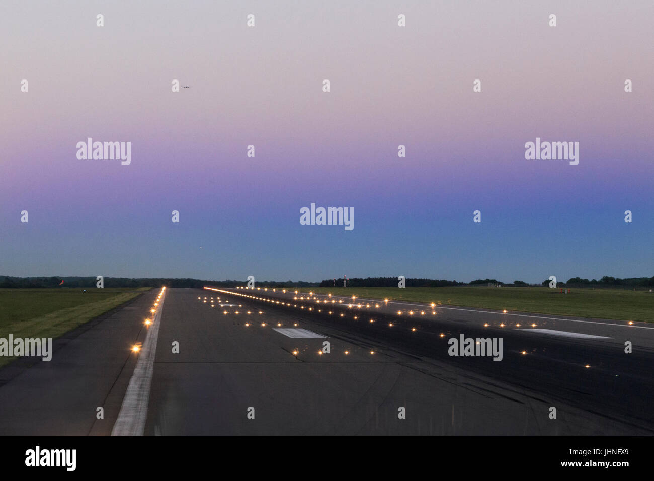 Sunset over an airplane runway Stock Photo - Alamy