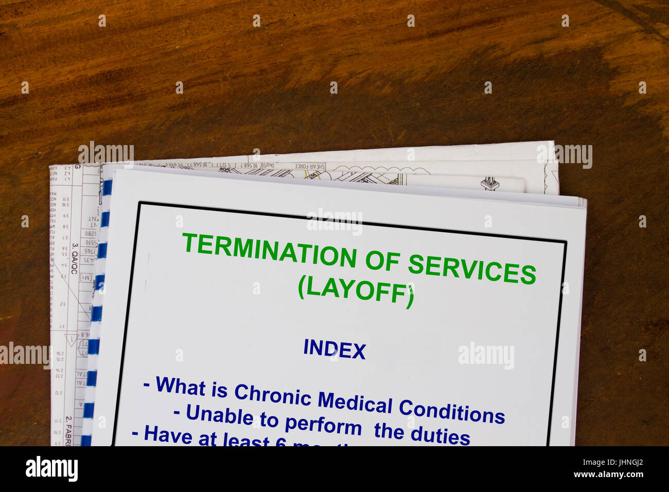 Layoff termination seminar with blueprints in a wood texture background ...