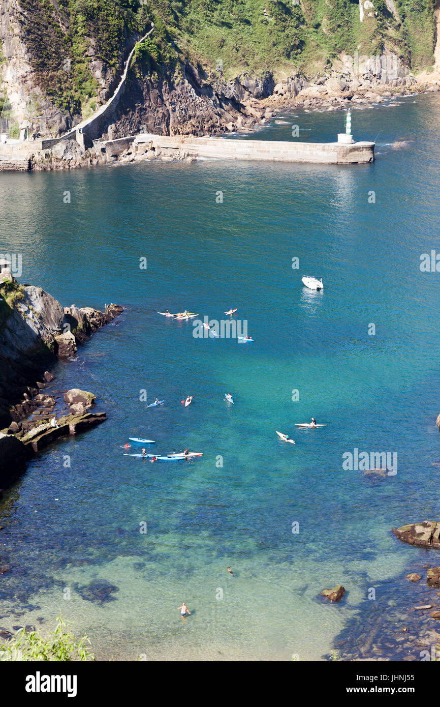 At Pasajes (Spain), a flock of teenagers practising canoeing in the ...
