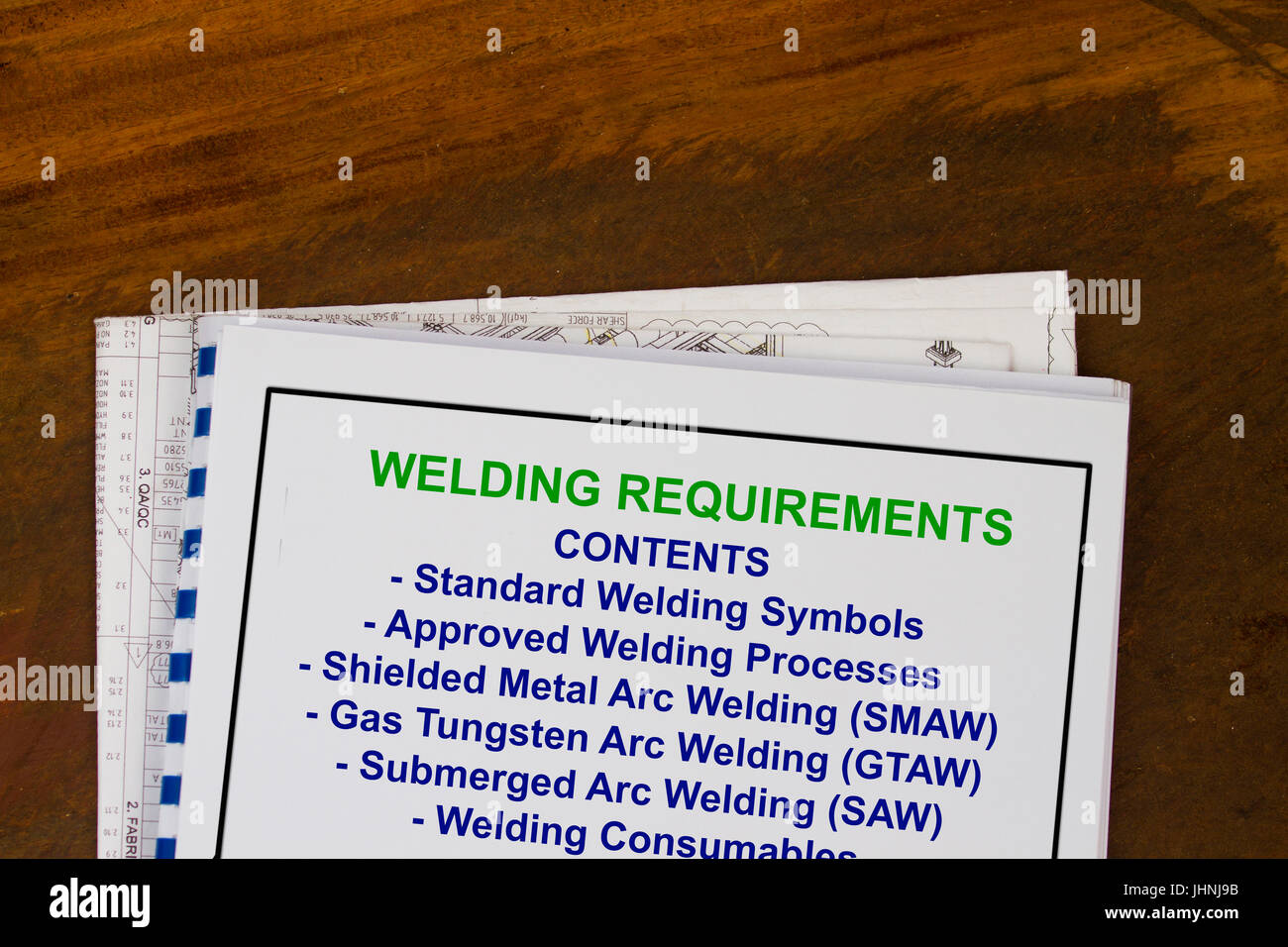 Welding requirements manual with blueprints in a wood texture ...