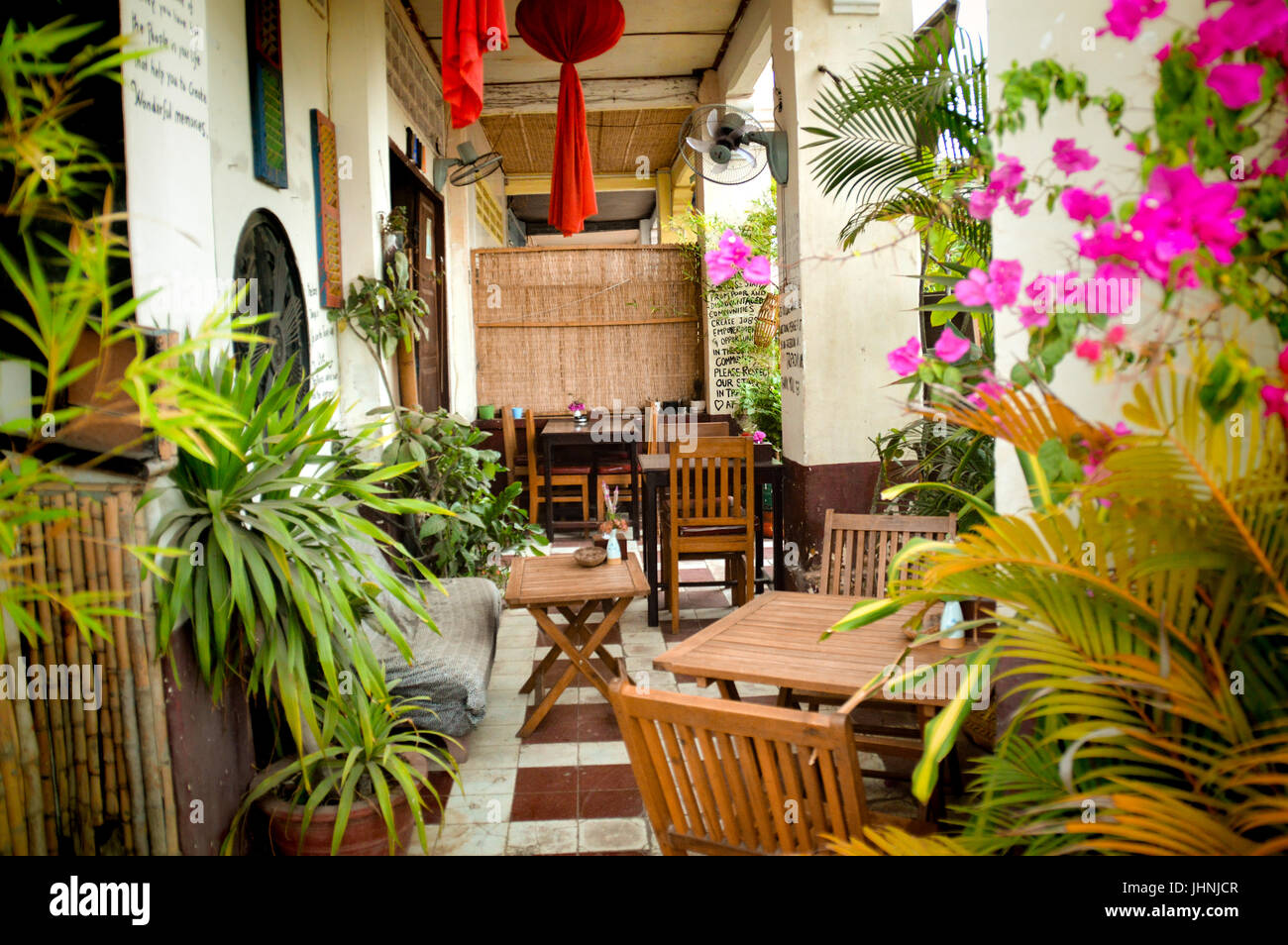Cuban style coffee shop with ratan chairs and tables Stock Photo - Alamy