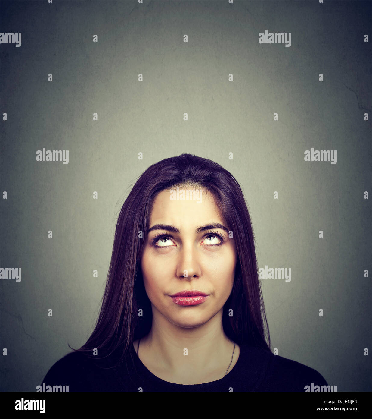 Thoughtful young woman looking up Stock Photo - Alamy Thoughtful young woman looking up Stock Photo - Alamy