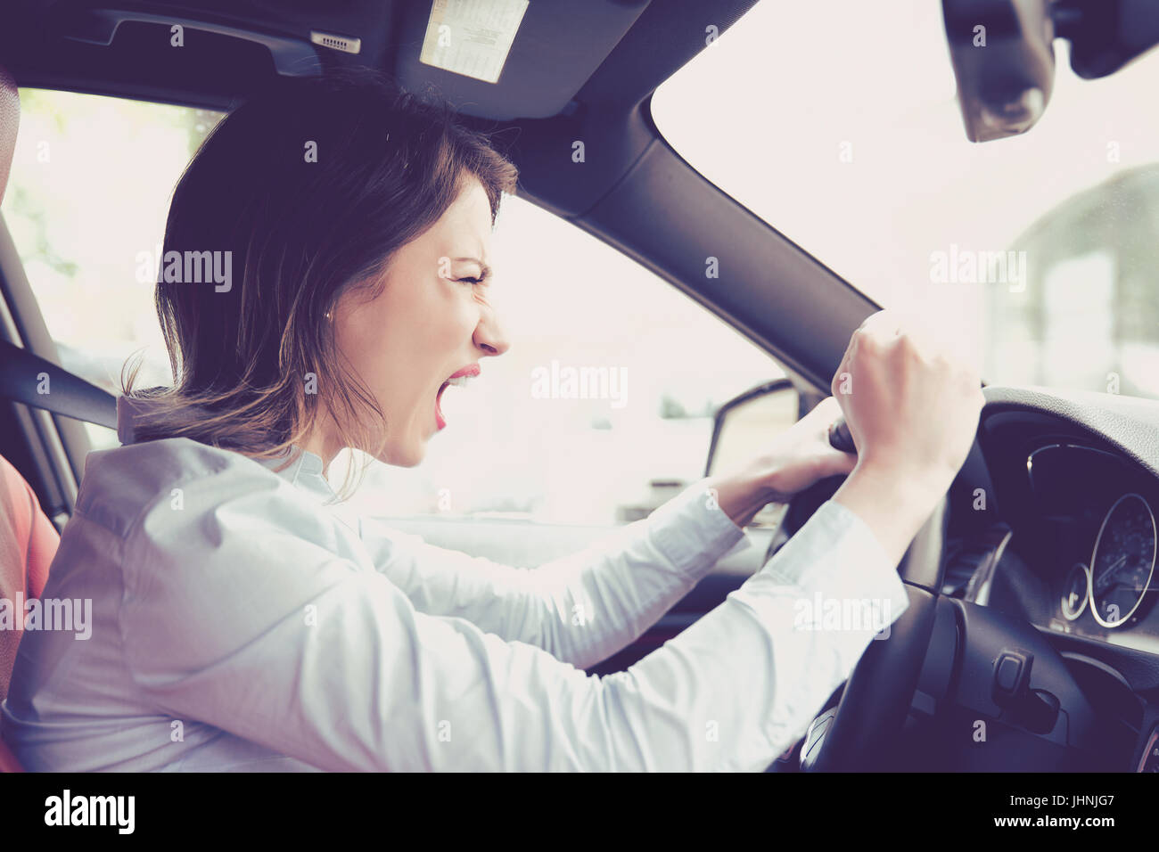 Side profile angry female driver. Negative human emotions face ...