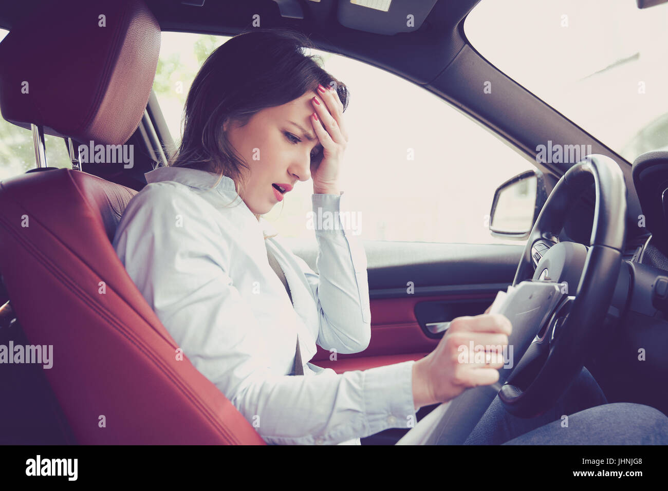 Stressed desperate woman driver with documents sitting inside her ...