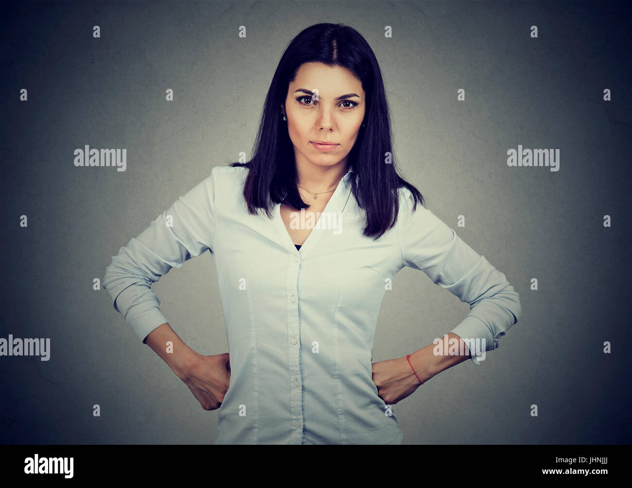 Angry brunette woman looking at camera Stock Photo - Alamy