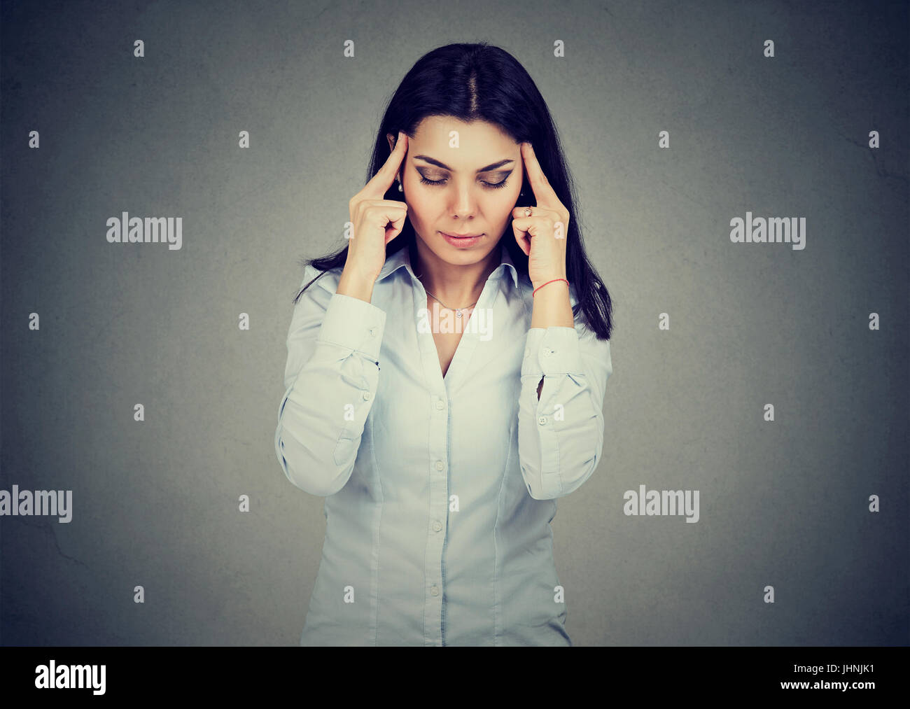 sad young woman with worried stressed face expression having headache ...