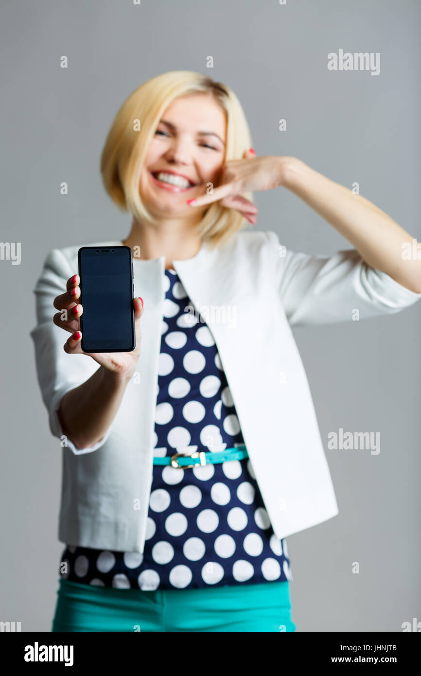 Girl with smartphone in hand Stock Photo - Alamy