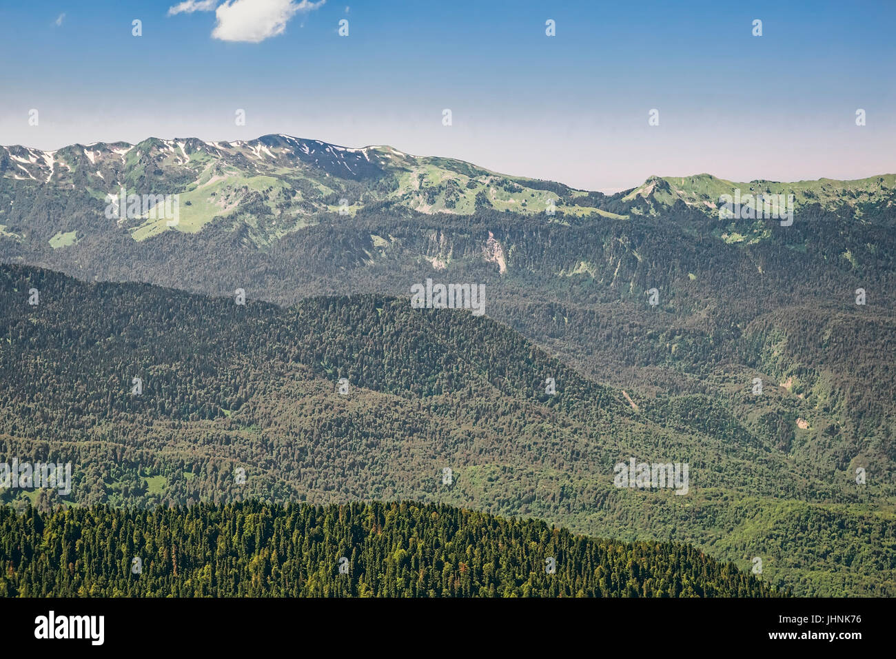 Mountain landscape: steep mountain slopes covered with forests, form a ...