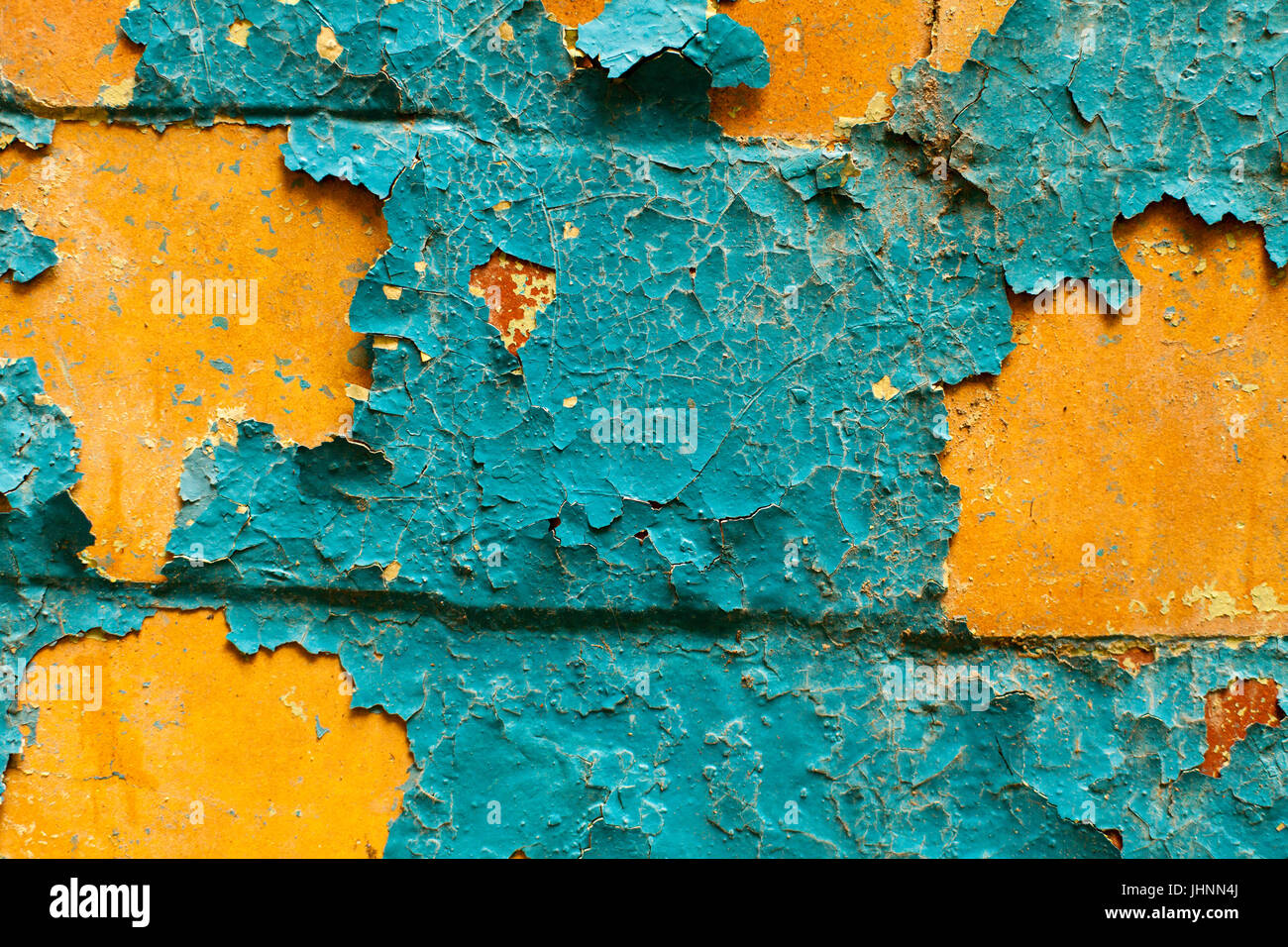 Cracked wall with old layers of paint in abandoned house. Background ...
