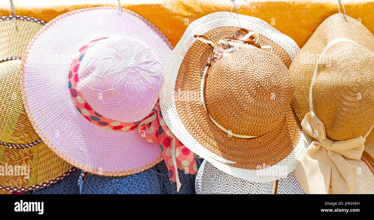 in a old market lots of colorated hats like background clothes Stock ...