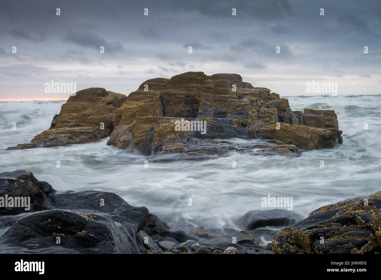 Rocks at Tresaith Beach, in stormy sea Stock Photo - Alamy