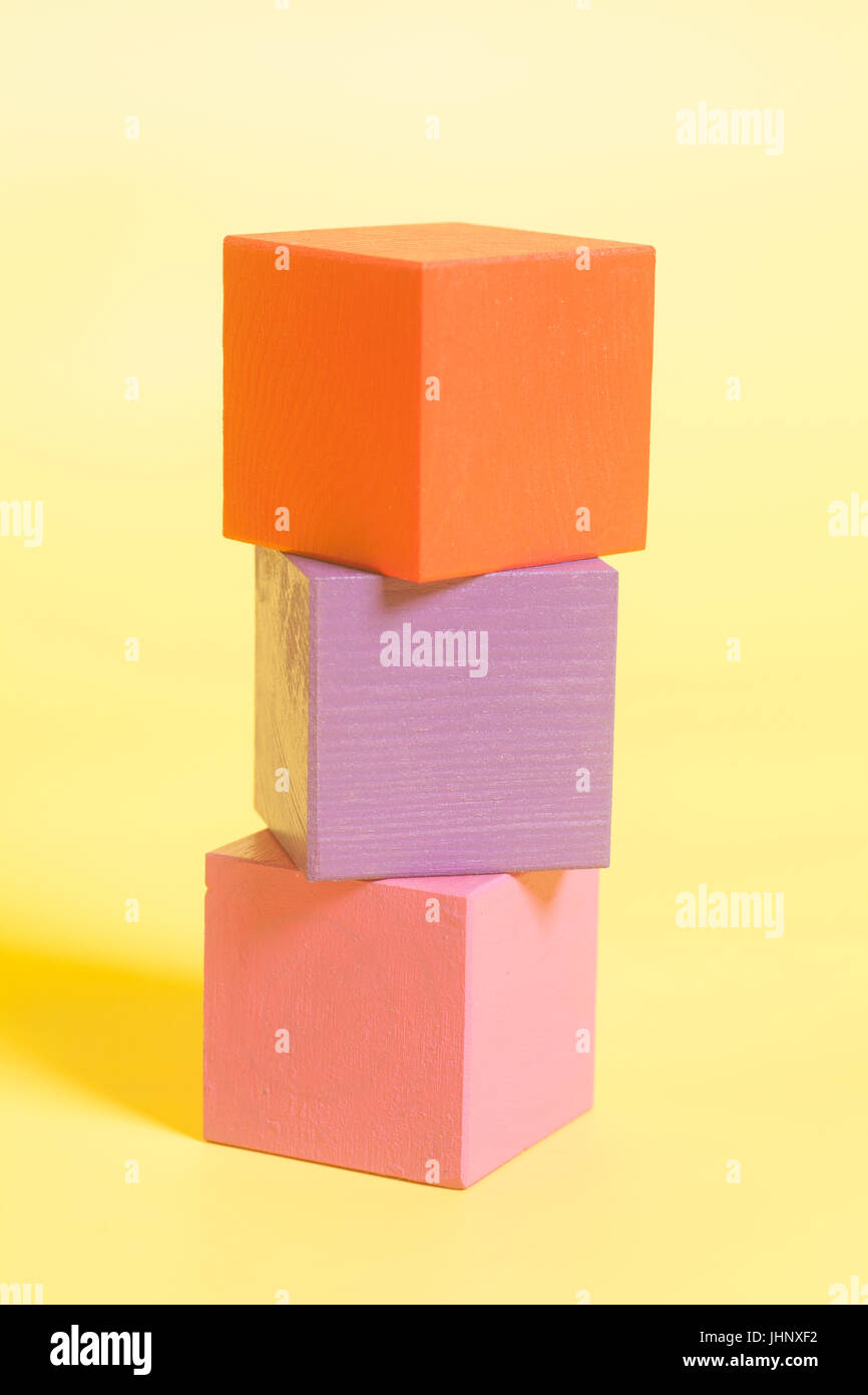 Multiple colored cubes on yellow background Stock Photo - Alamy