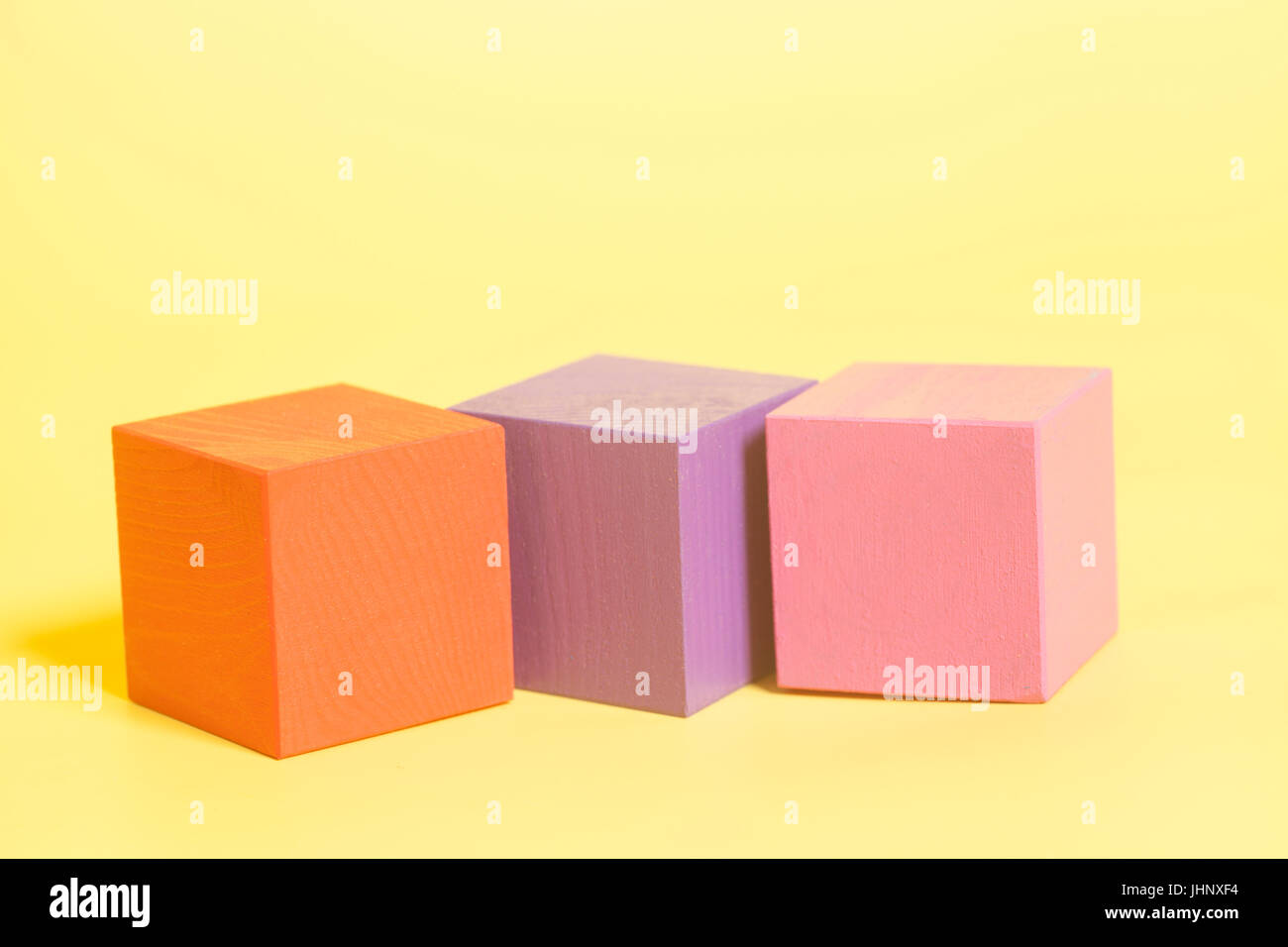 Multiple colored cubes on yellow background Stock Photo - Alamy