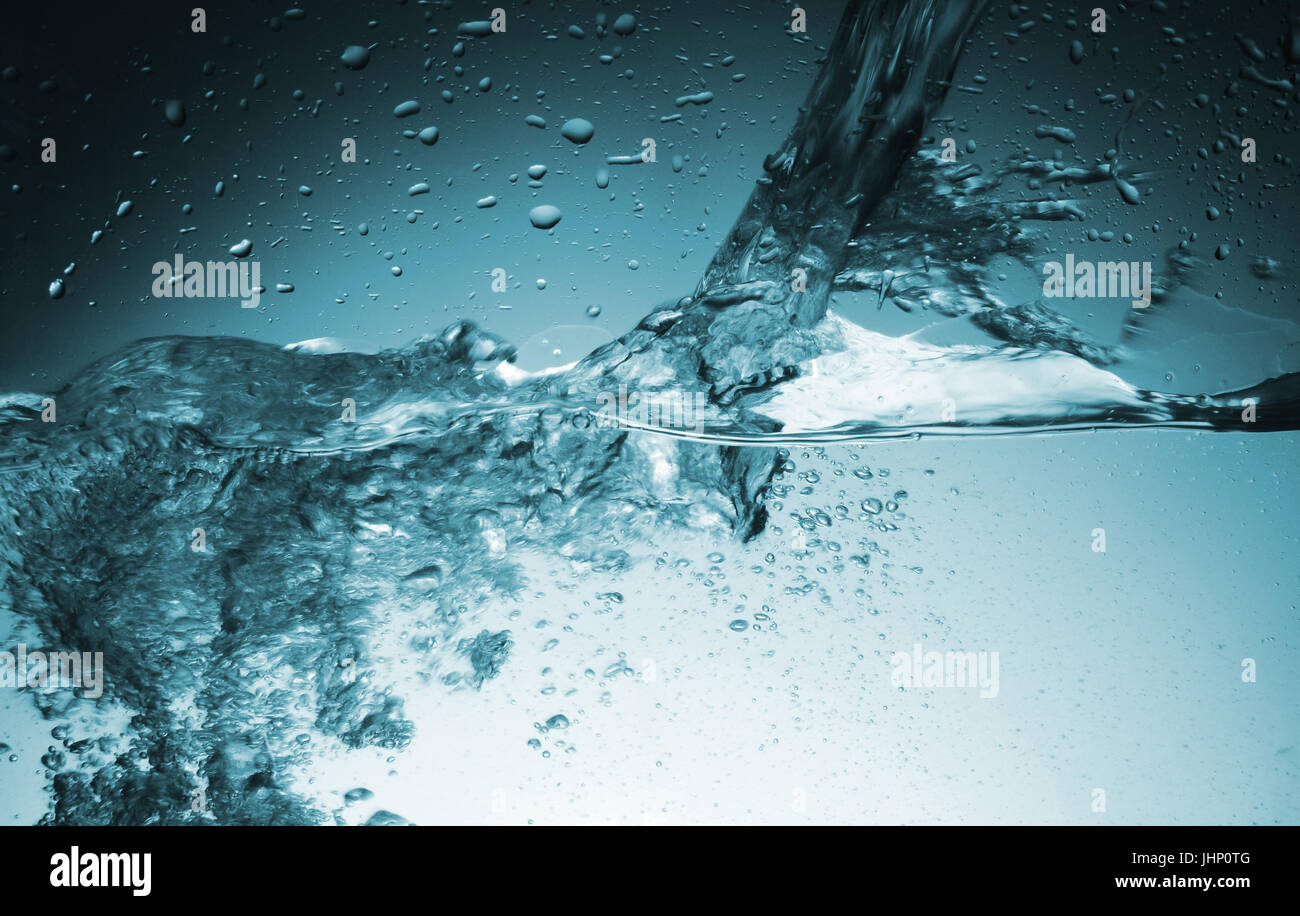 water pouring and splashing into clear tank of water Stock Photo - Alamy