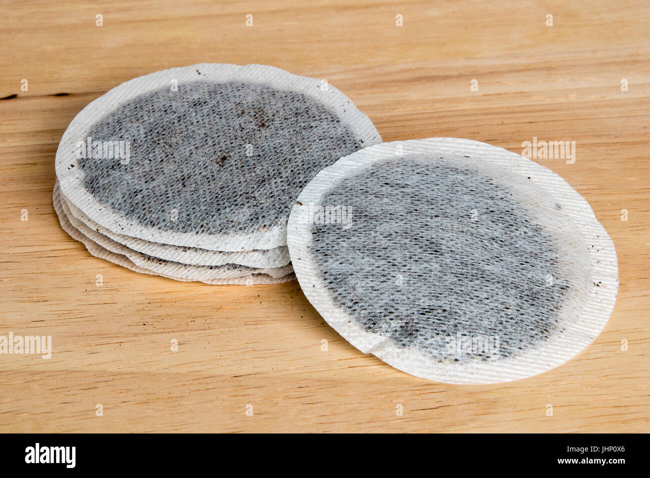 Round tea bags on a wooden background Stock Photo - Alamy