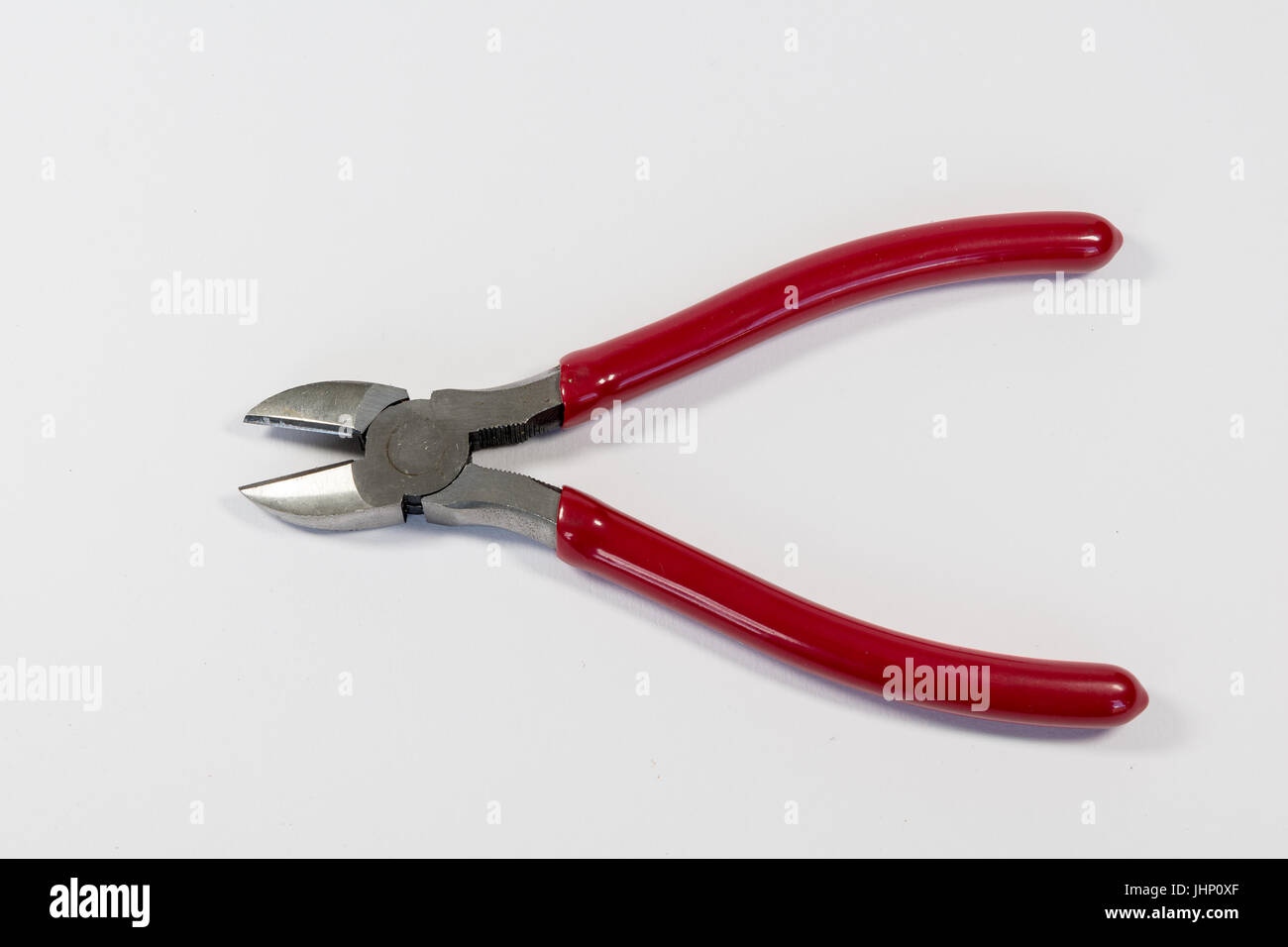 Red handle wire cutters on a white background Stock Photo - Alamy