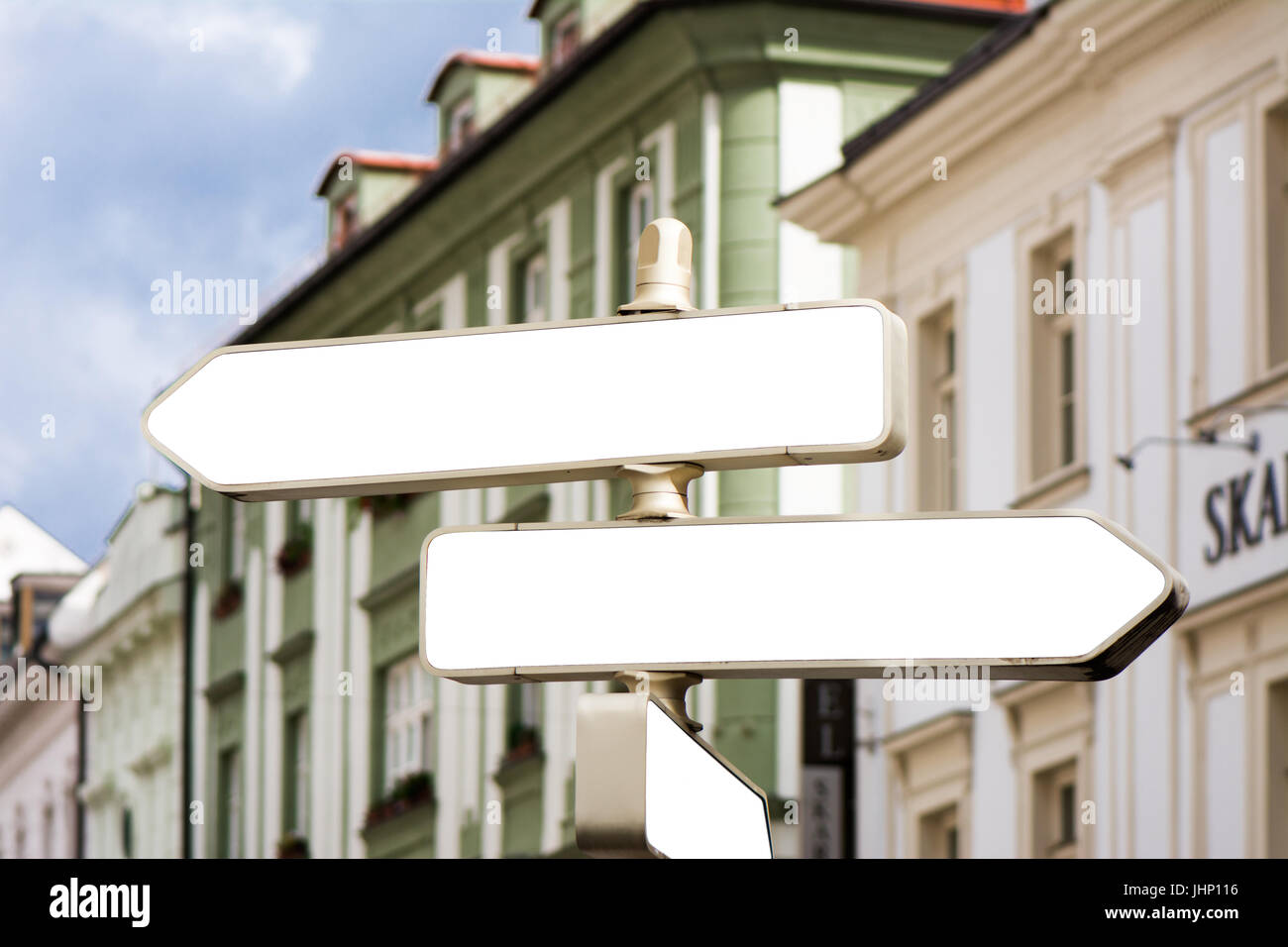 Blank guide post in the city, behind, building with classical ...