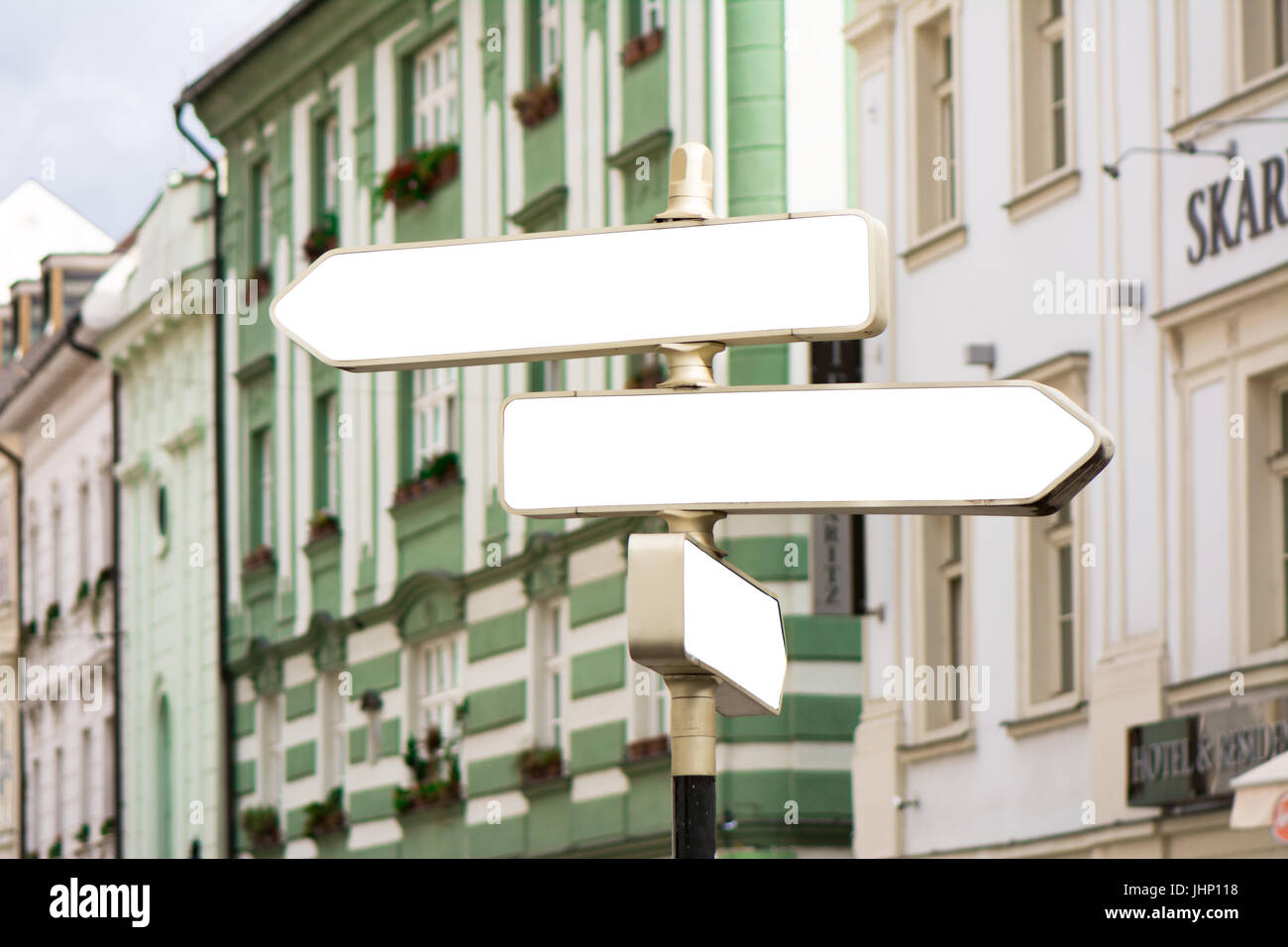 Blank guide post in the city, behind, building with classical ...