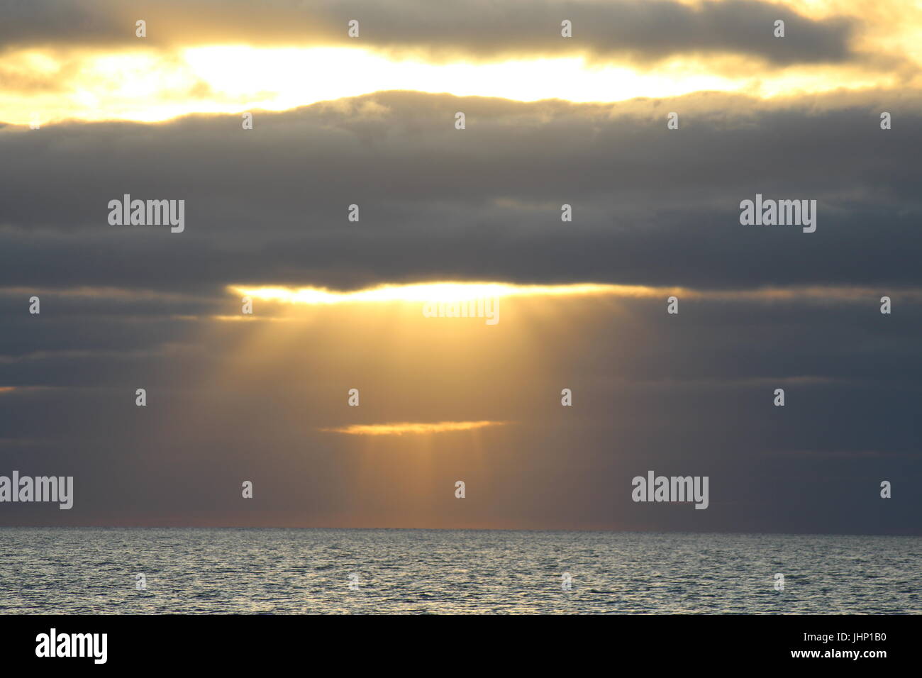 Shining through dark clouds on sea hi-res stock photography and images ...