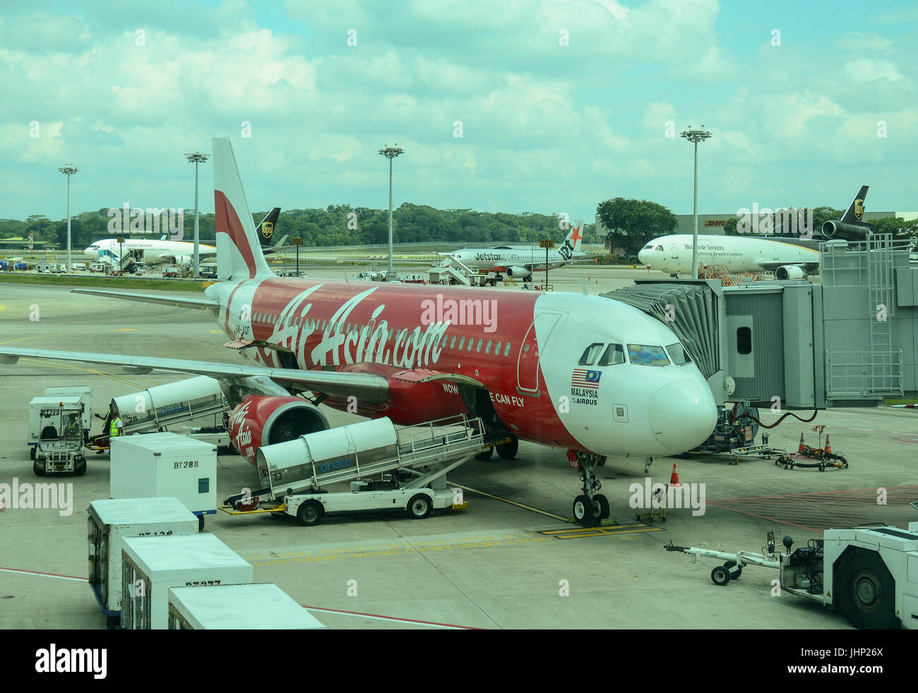 Singapore - Mar 12, 2016. An AirAsia airplane docking at Changi Airport ...