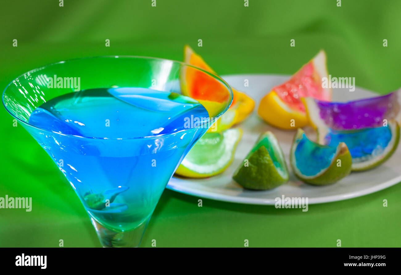 a cup of blue sky drink with colorful lemon in green background Stock ...