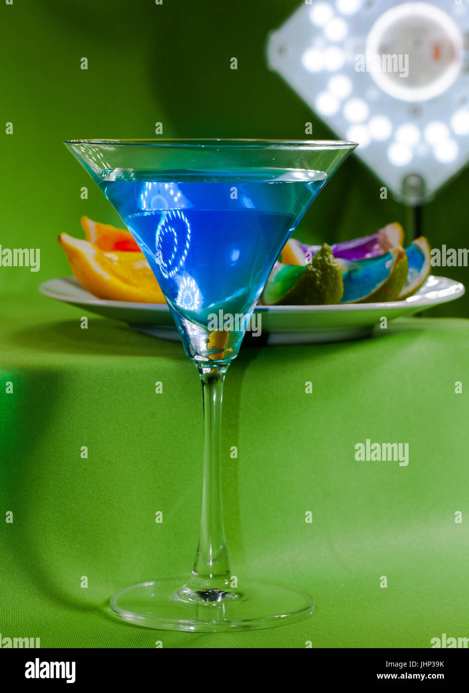 a cup of blue sky drink with colorful lemon in green background Stock ...