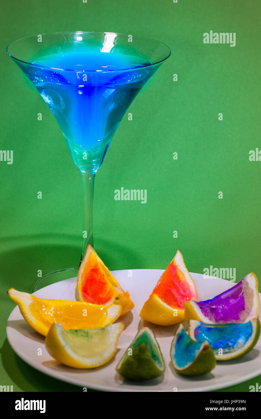 a cup of blue sky drink with colorful lemon in green background Stock ...