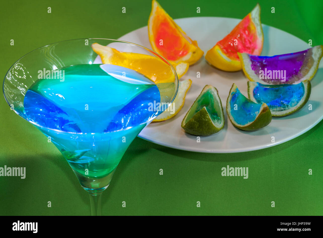 a cup of blue sky drink with colorful lemon in green background Stock ...