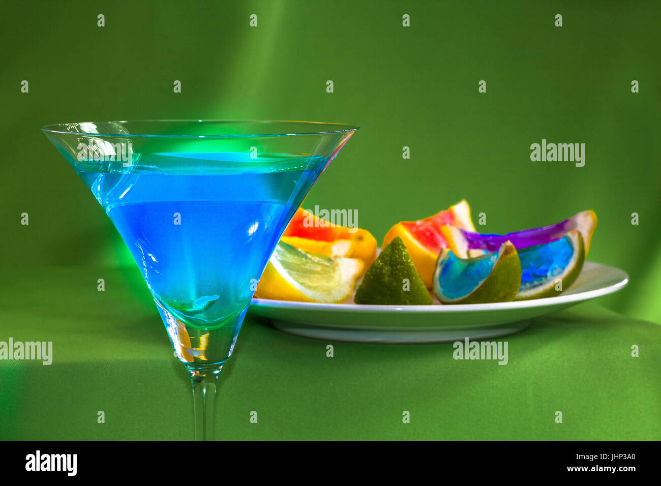 a cup of blue sky drink with colorful lemon in green background Stock ...