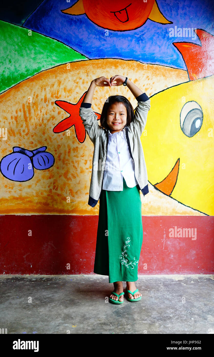 Yangon, Myanmar - Oct 16, 2015. A highschool student standing at ...