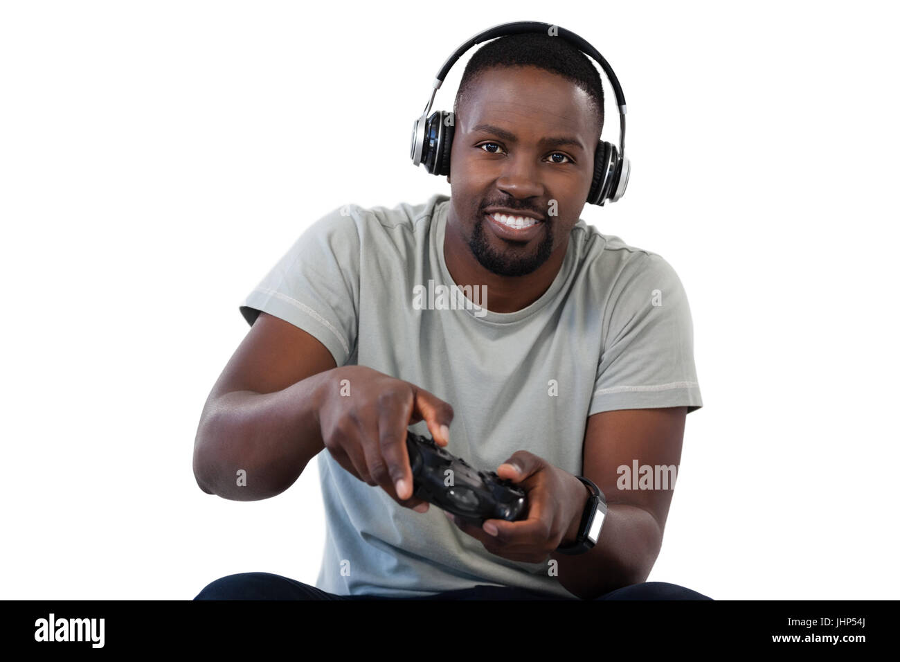 Portrait of smiling man playing video game against white background ...