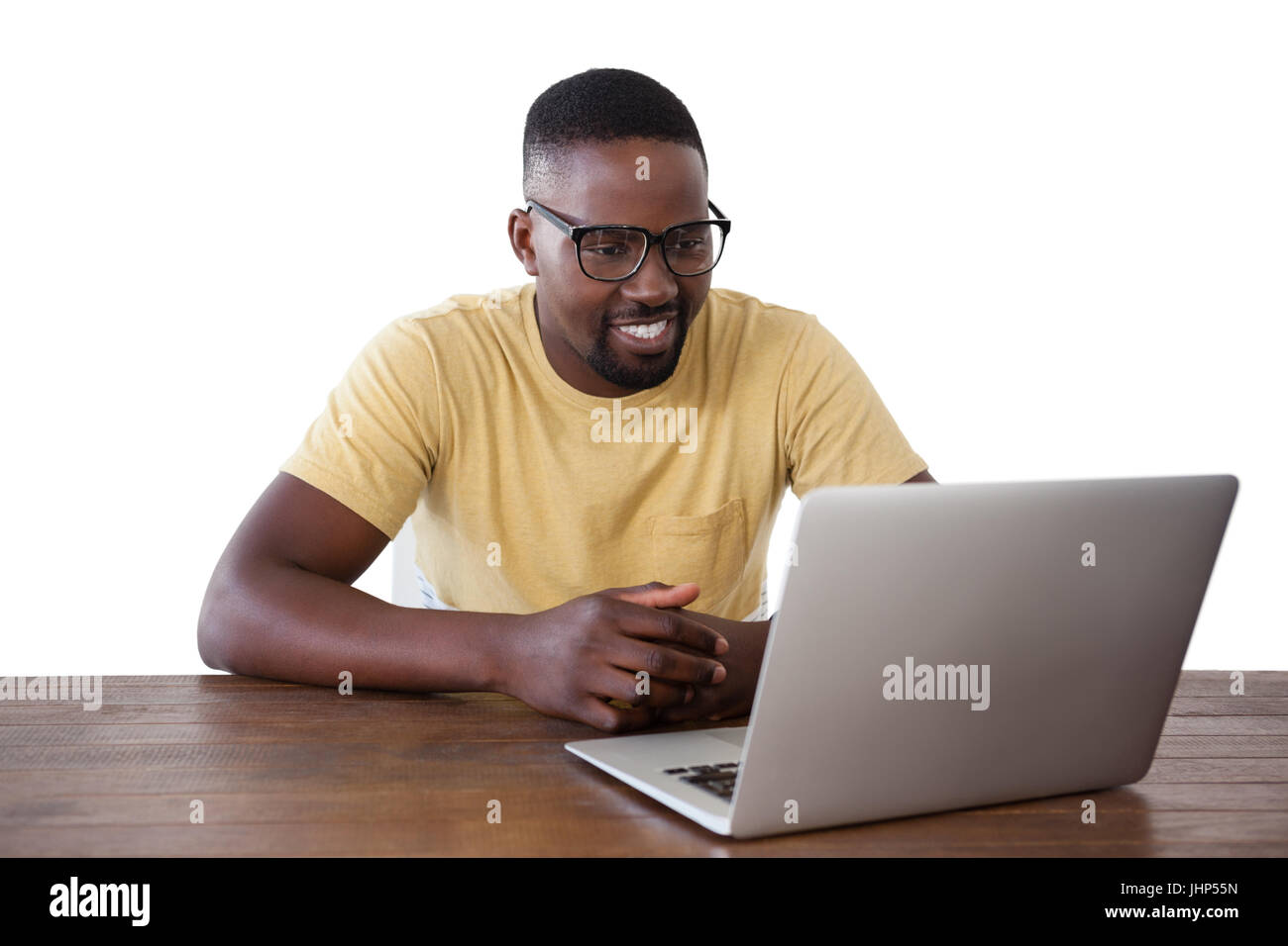 Smiling man using laptop against white background Stock Photo - Alamy