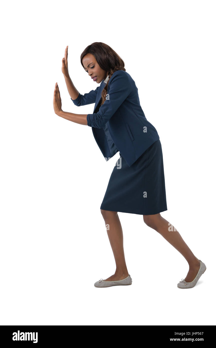 Full length of young businesswoman pushing something on white ...