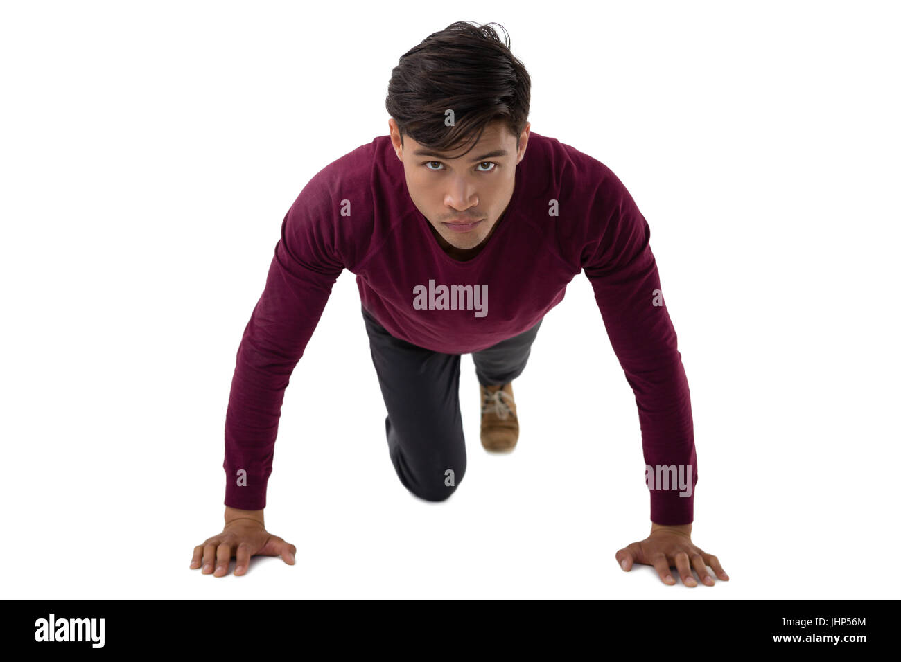 Portrait of businessman doing push ups against white background Stock ...