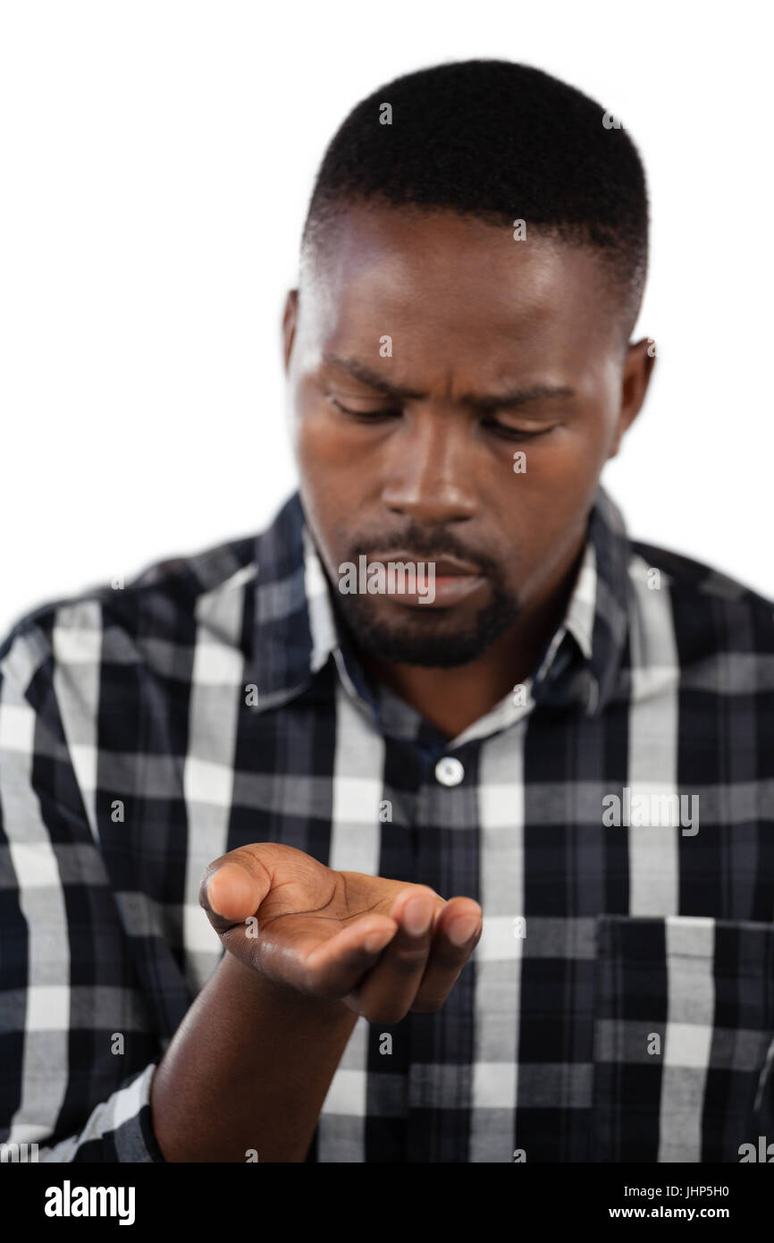Thoughtful man gesturing against white background Stock Photo - Alamy