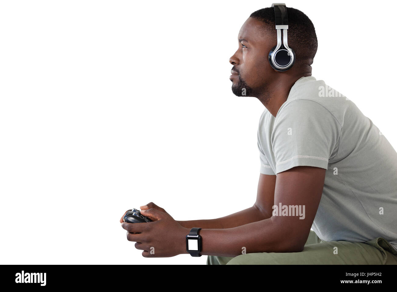Side view of man playing video game against white background Stock ...