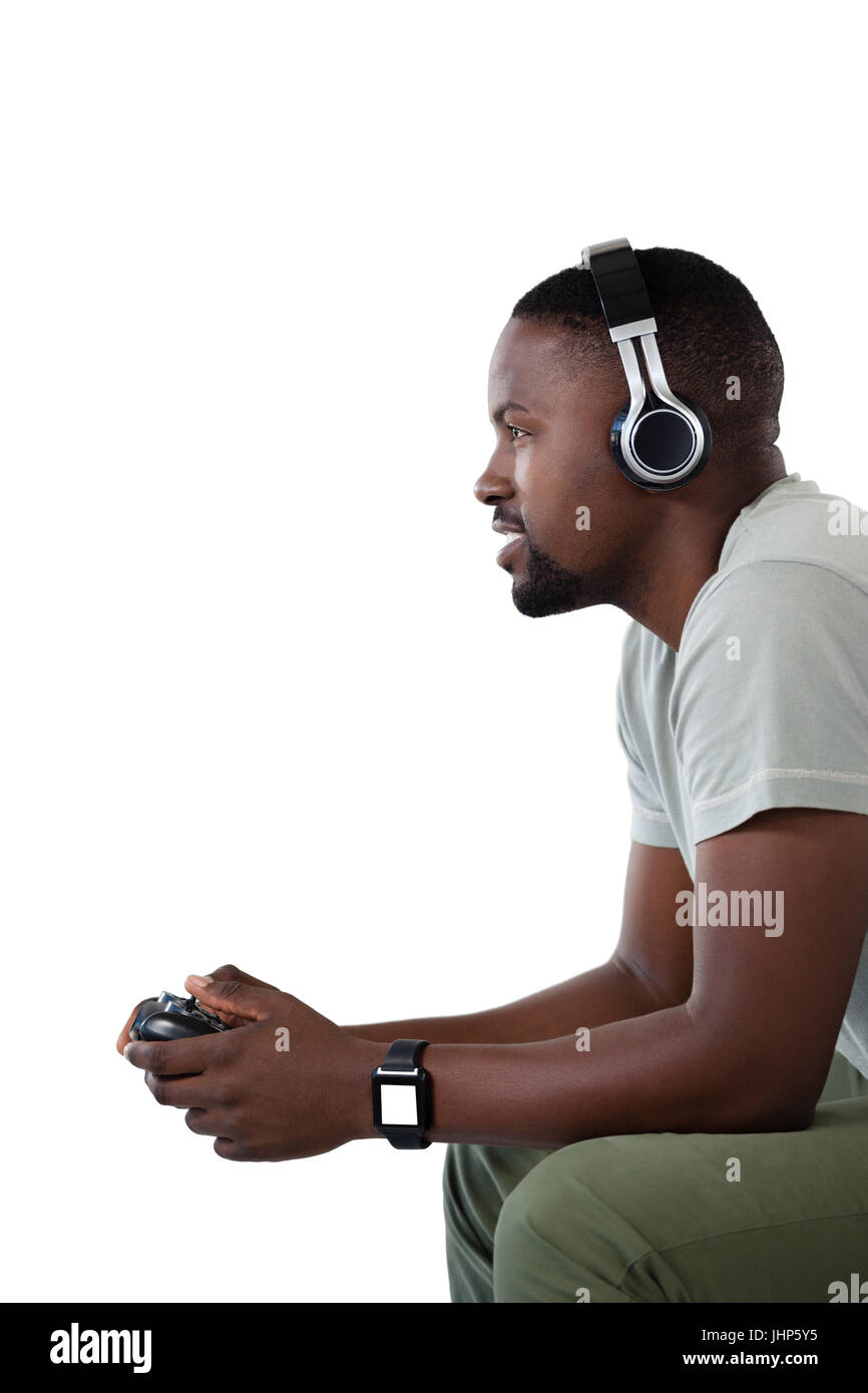 Side view of man playing video game against white background Stock ...