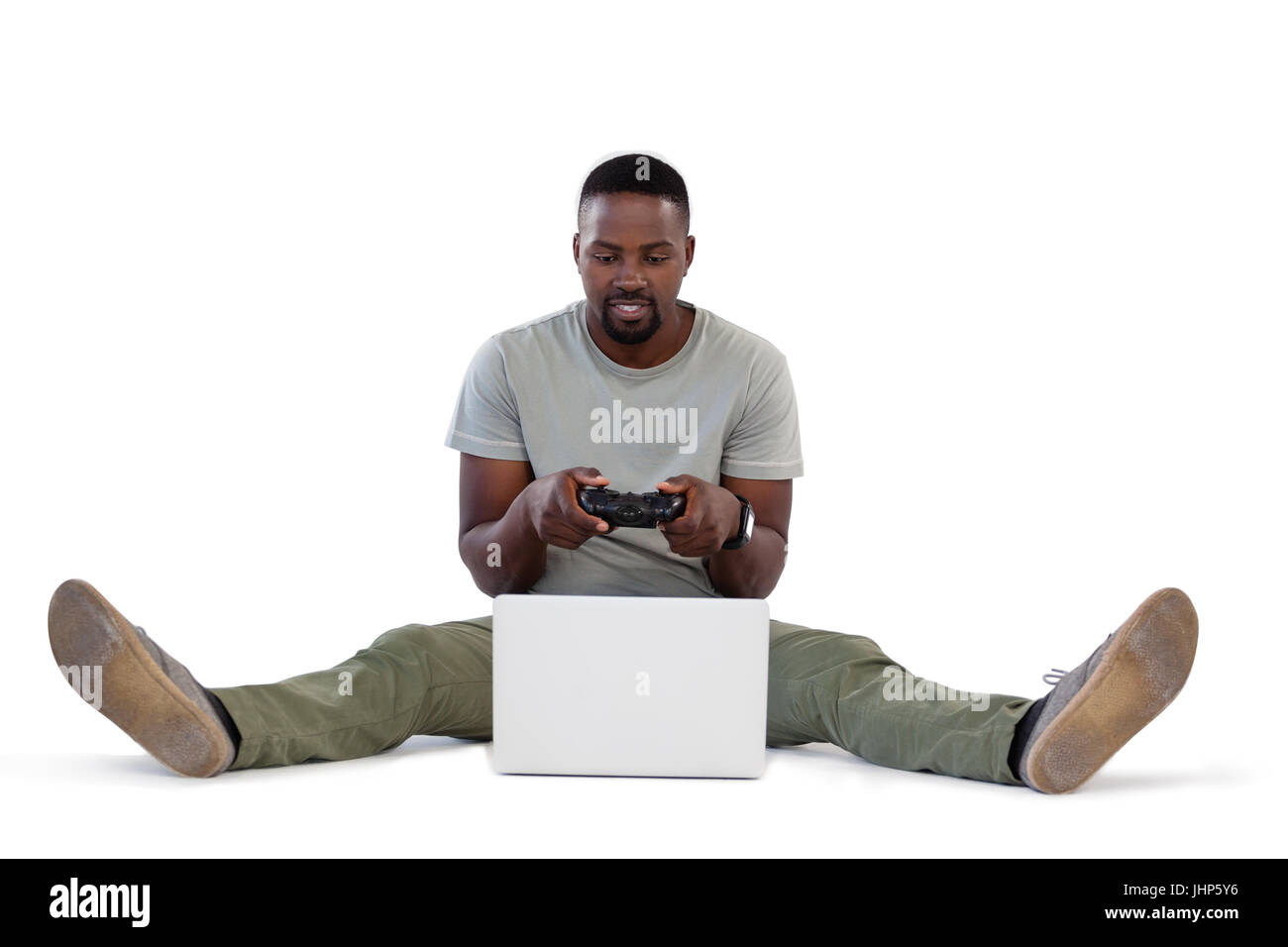 Man playing video game on laptop against white background Stock Photo ...