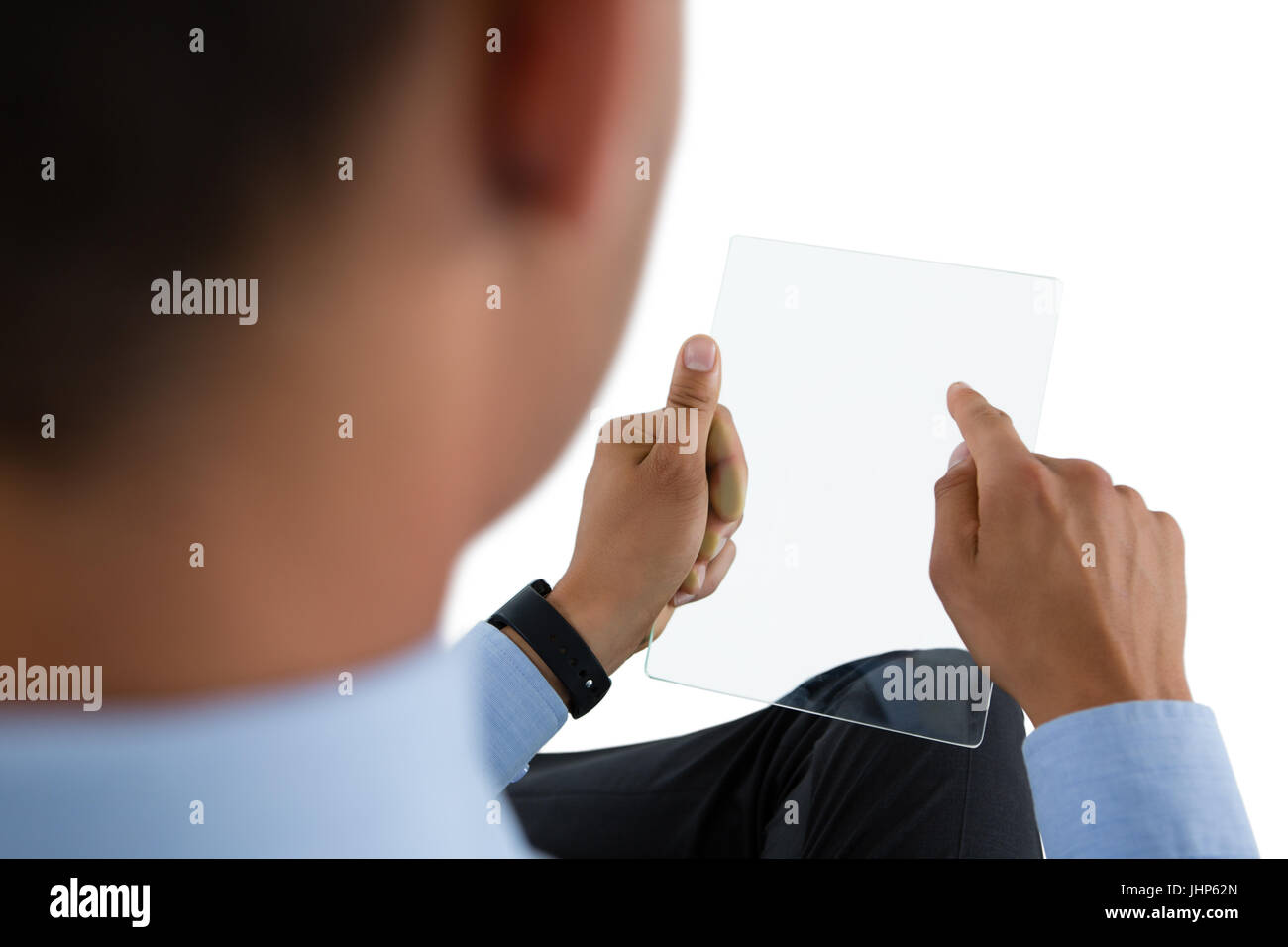 Close up of businessman using glass interface against white background ...