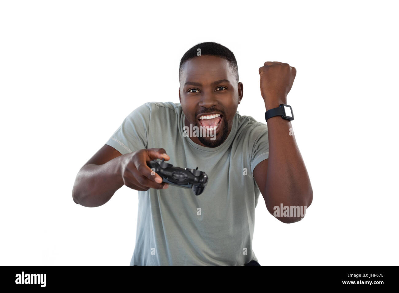 Excited man playing video game against white background Stock Photo - Alamy