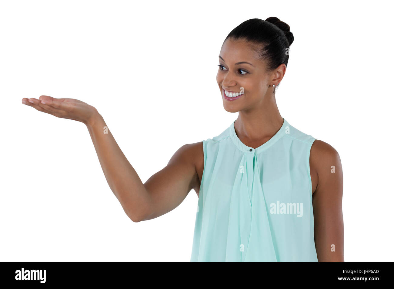Smiling businesswoman making hand gesture while presenting Stock Photo ...