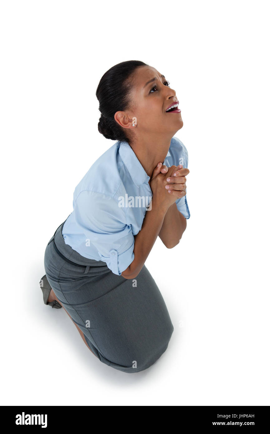 Worried businesswoman pleading against white background Stock Photo - Alamy