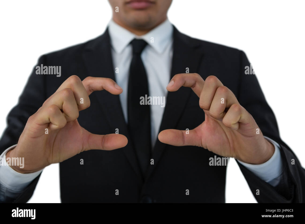 Businessman gesturing against white background Stock Photo - Alamy