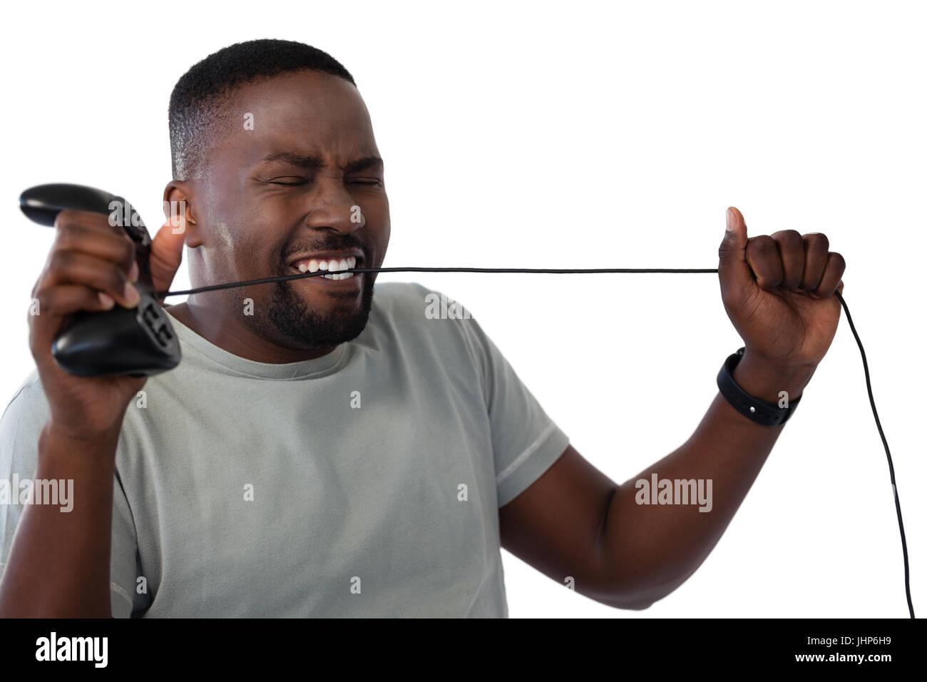 Frustrated man biting a wire of joystick against white background Stock ...
