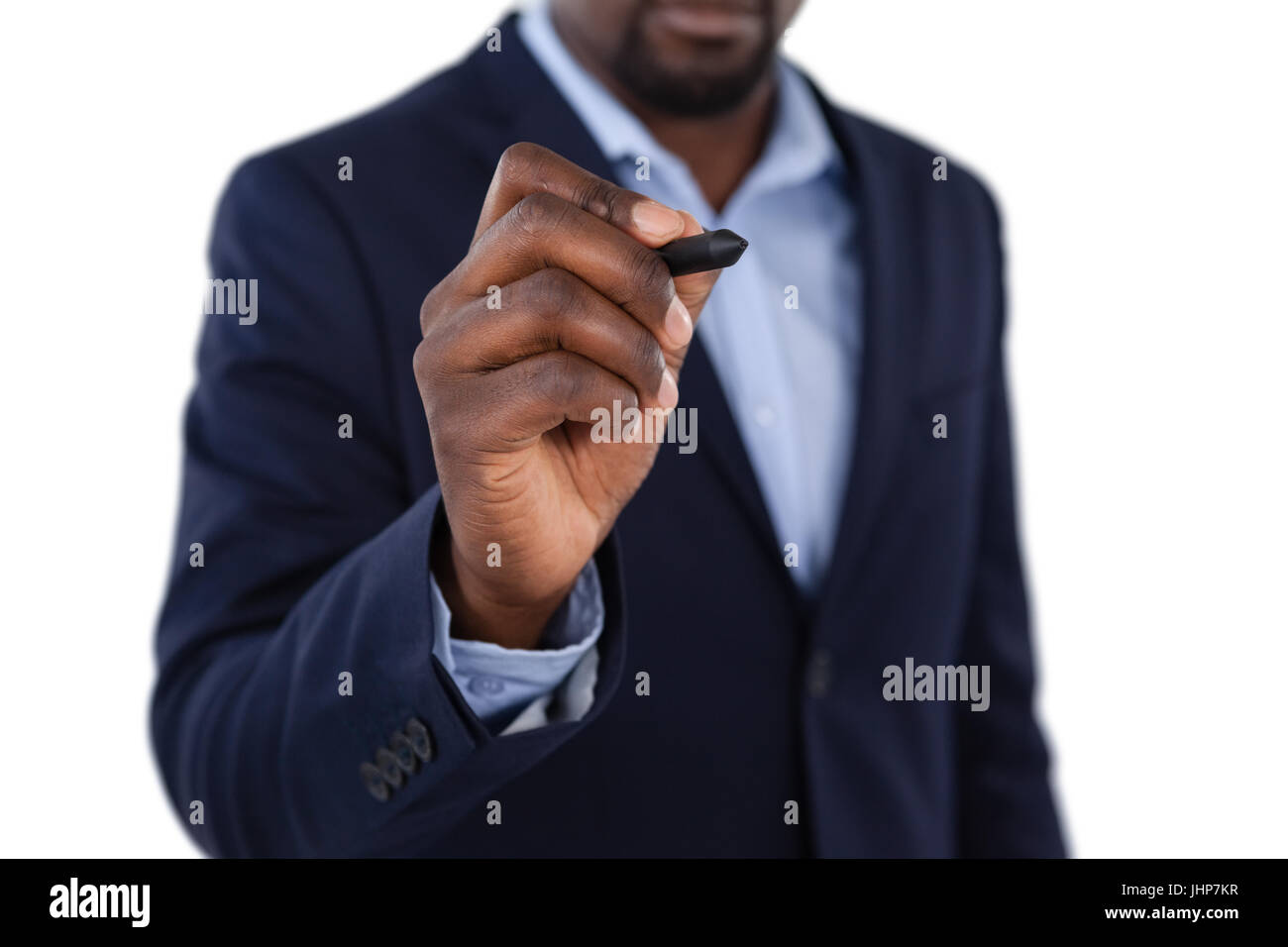Mid section of businessman pretending to write on invisible screen ...