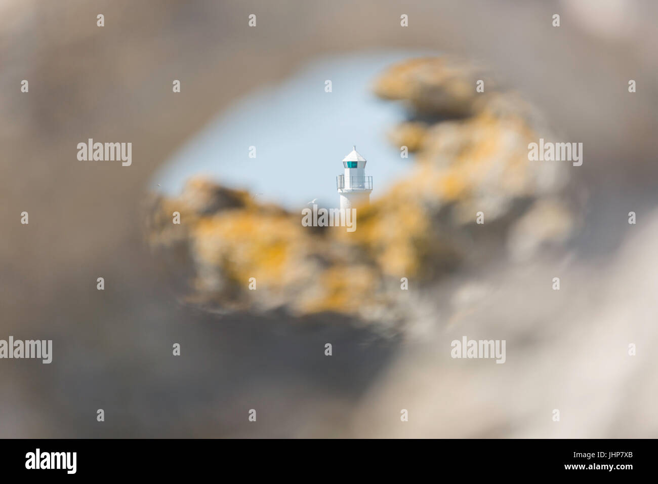 Lighthouse through Whole in Limestone Stock Photo - Alamy