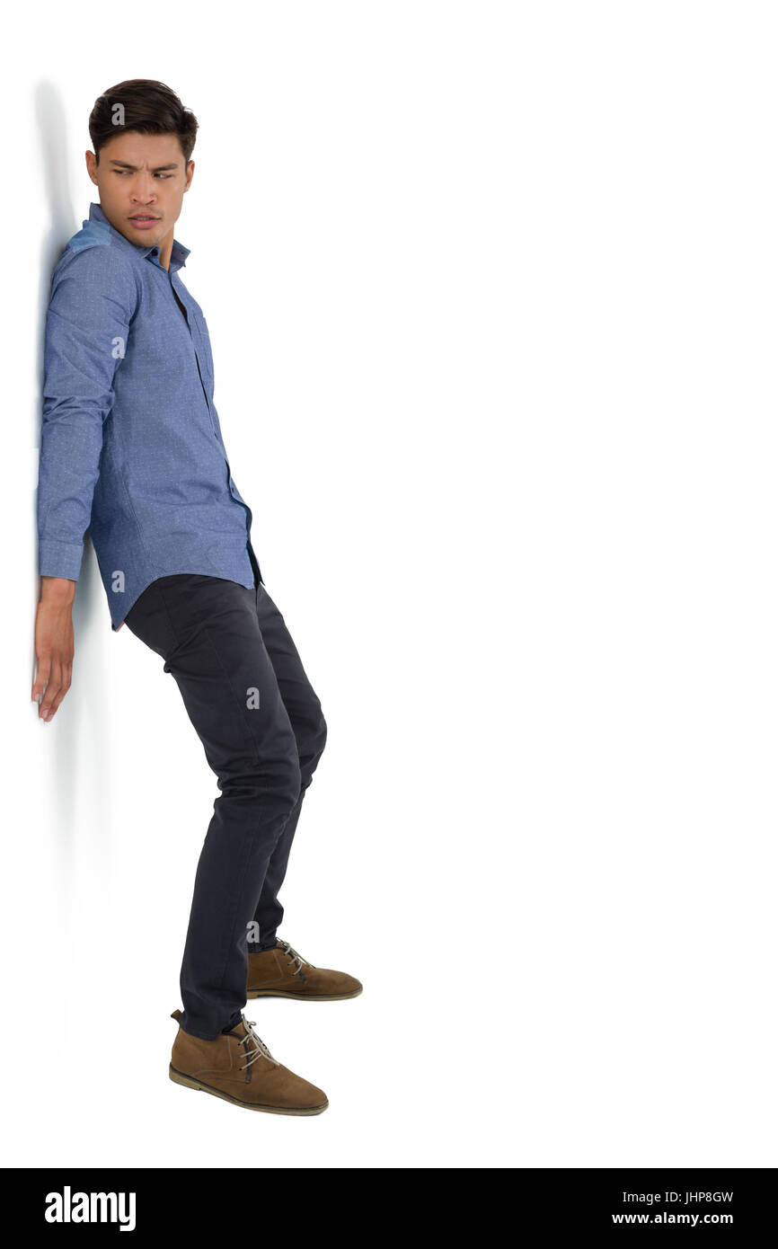 Full length of businessman pushing something against white background ...